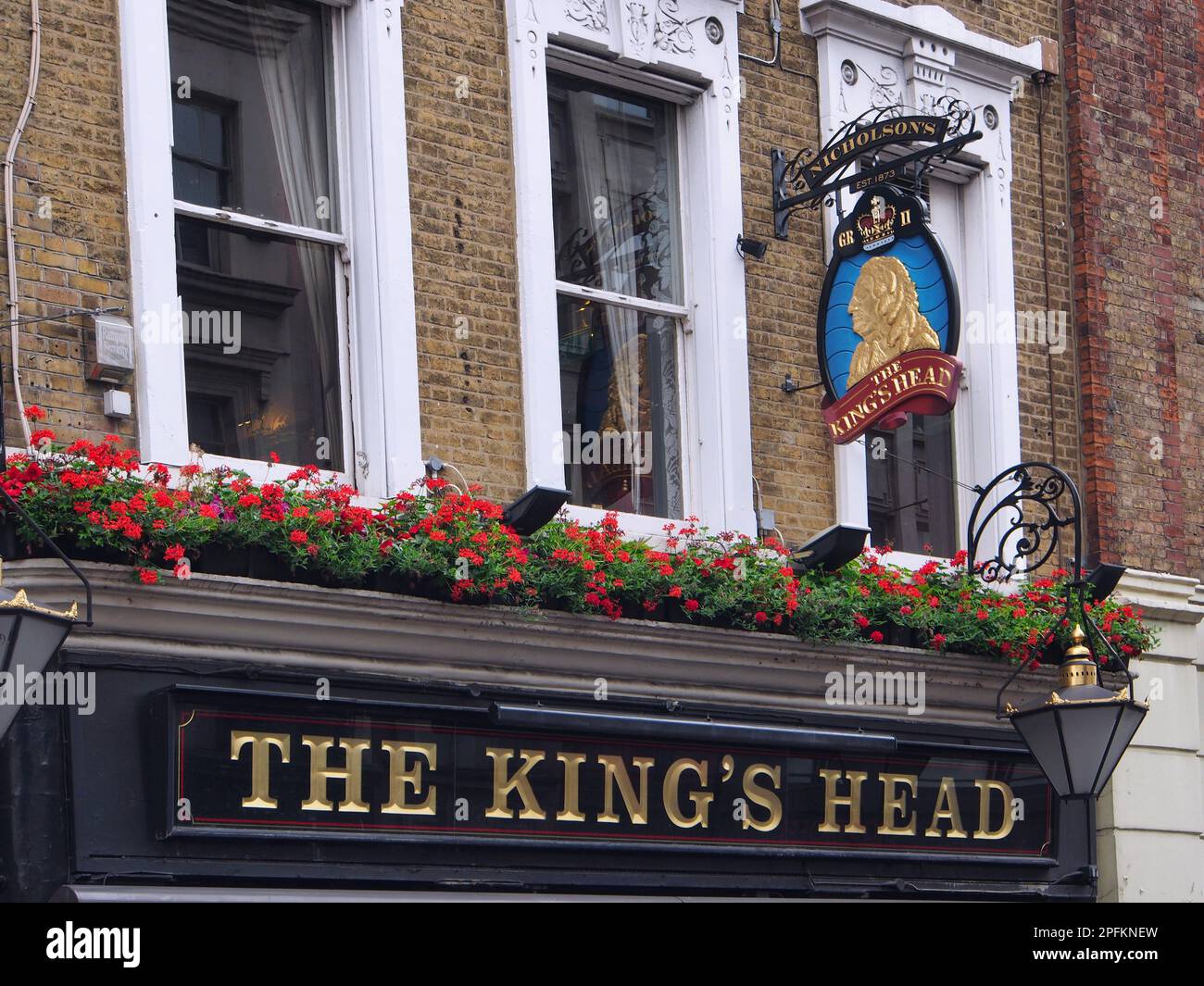 Gilded lettering in sign of pub in central London, exterior decorated ...