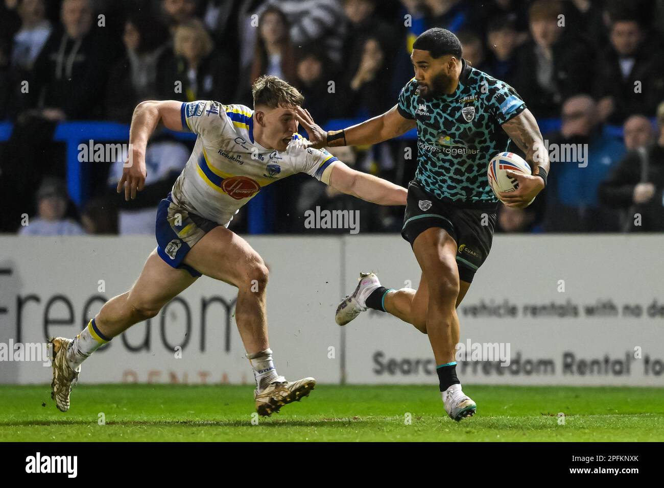 Ricky Leutele #4 of Leigh Leopards fends off Matty Nicholson #12 of ...
