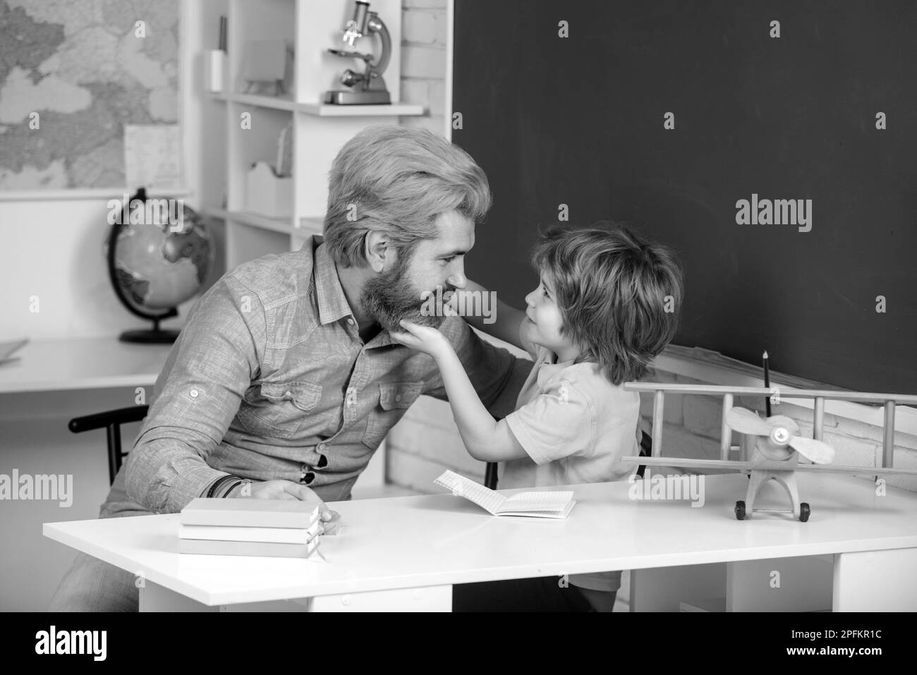Father teaching son. Supporting pupils at school. Education background ...
