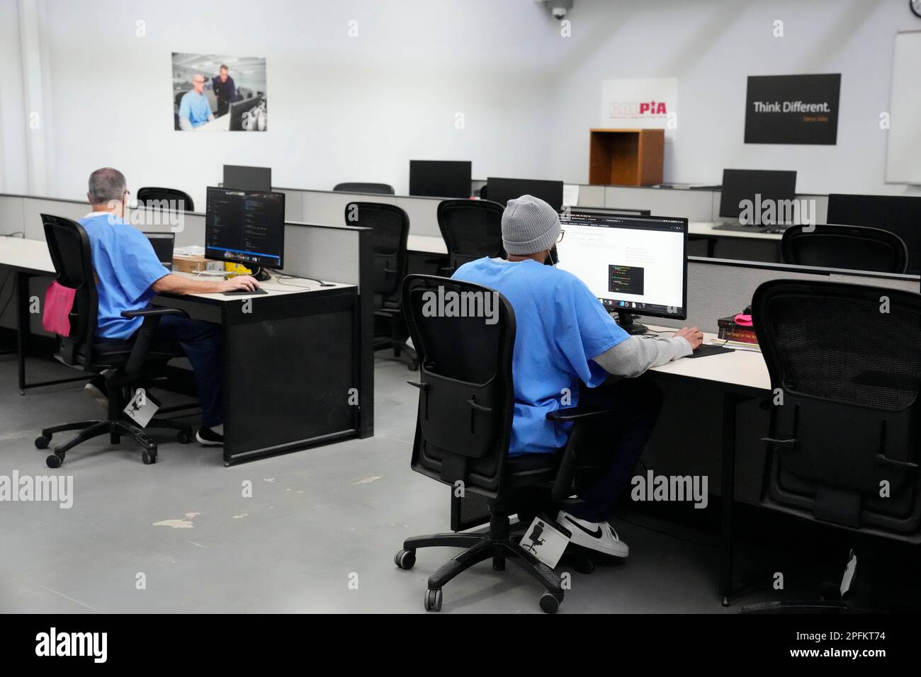 A pair of incarcerated men work in the coding center at San Quentin ...