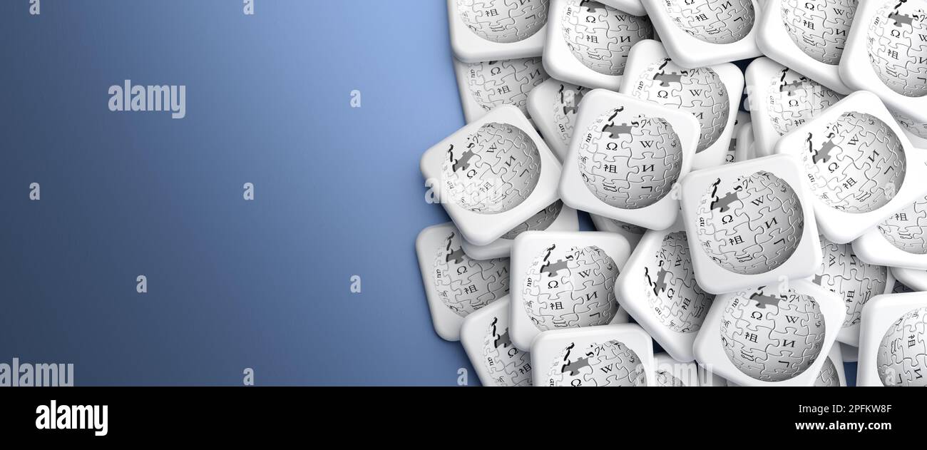 Logos of the online encyclopedia wikipedia on a heap on a table. Web ...