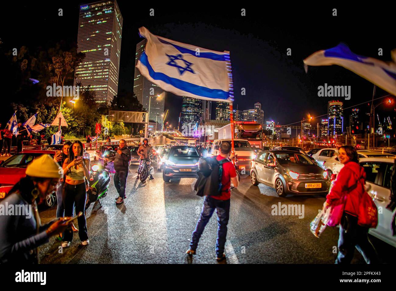 Tel Aviv, Israel. 16th Mar, 2023. A protester waves the Israeli flag as ...