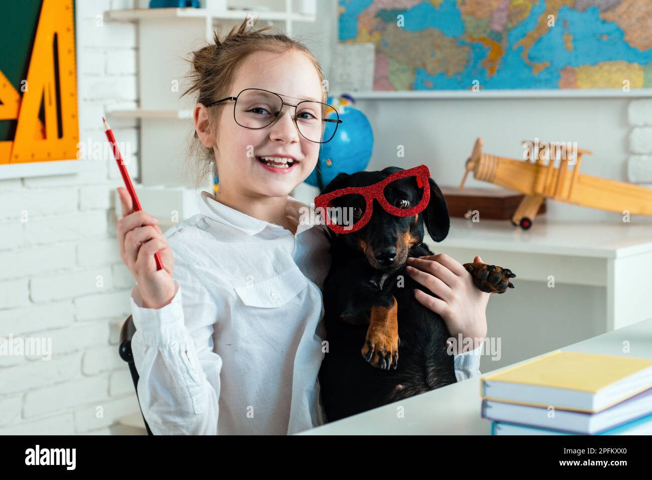 Funny puppi and pupil. Child girl with puppi. Happy smiling kid go back ...