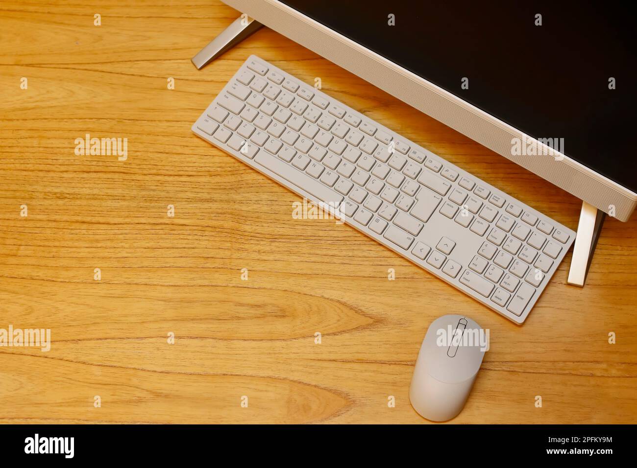 elegant light wood work desk with keyboard, mouse and white computer ...