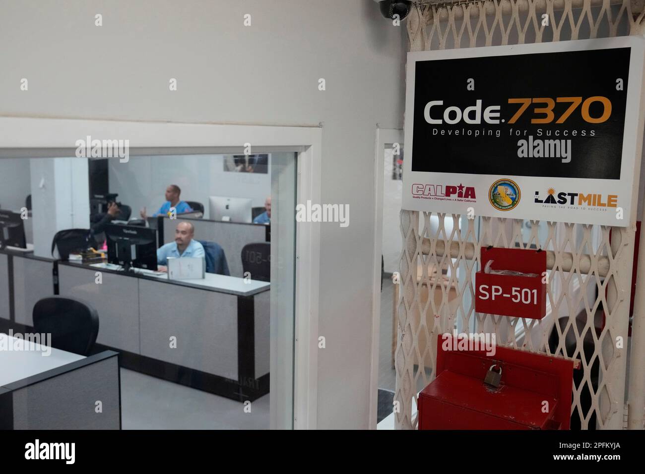 Incarcerated men work in the coding center at San Quentin State Prison ...