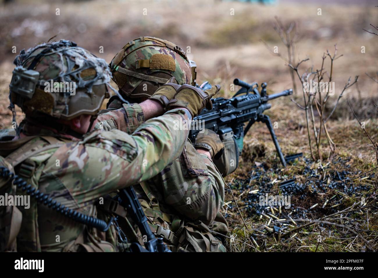 A team leader measures the limit of fire for the M249 Squad Automatic ...