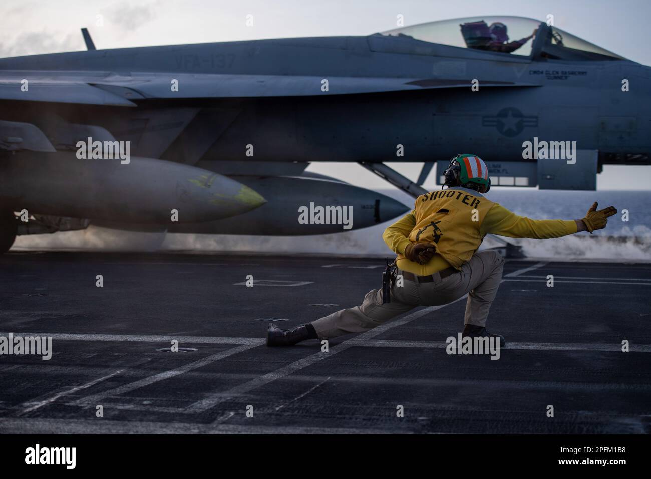 230316-N-WM182-3037 PHILIPPINE SEA (March 16, 2023) A U.S. Navy Sailor launches an F/A-18E Super ...
