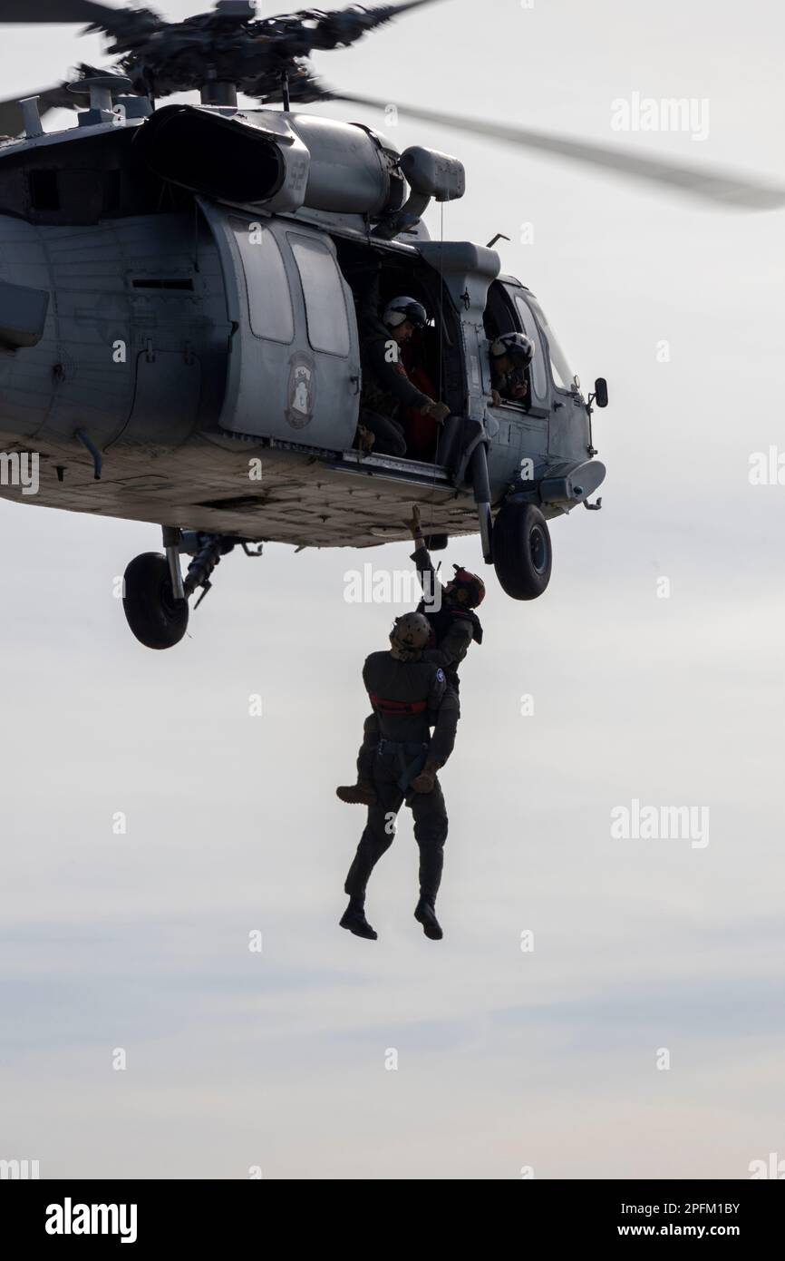 U.S. Navy Hospital Corpsman 1st Class Patrick Shea, right, lifts U.S ...