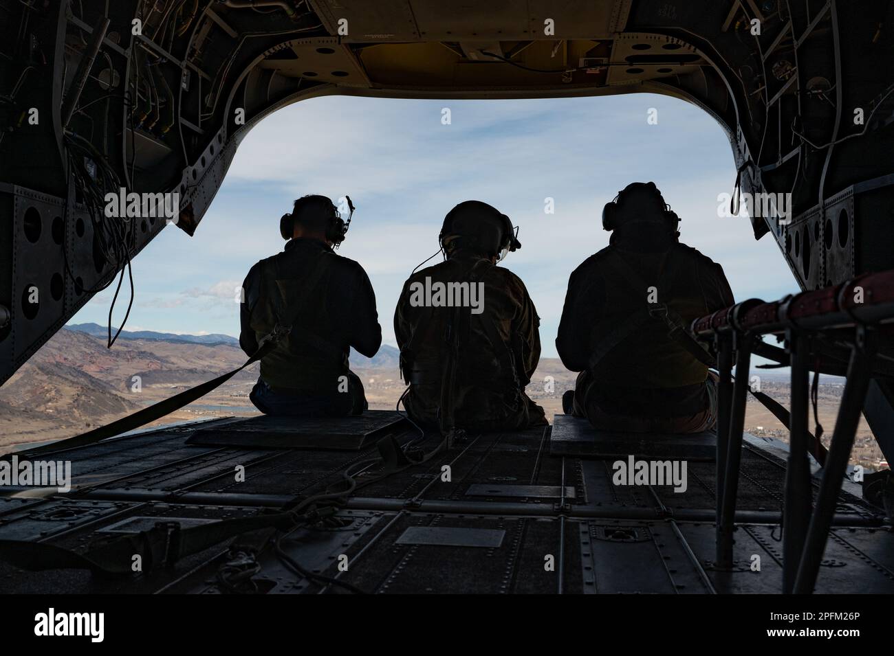 Service members from Buckley Space Force Base, Colo. sit on the rear ...