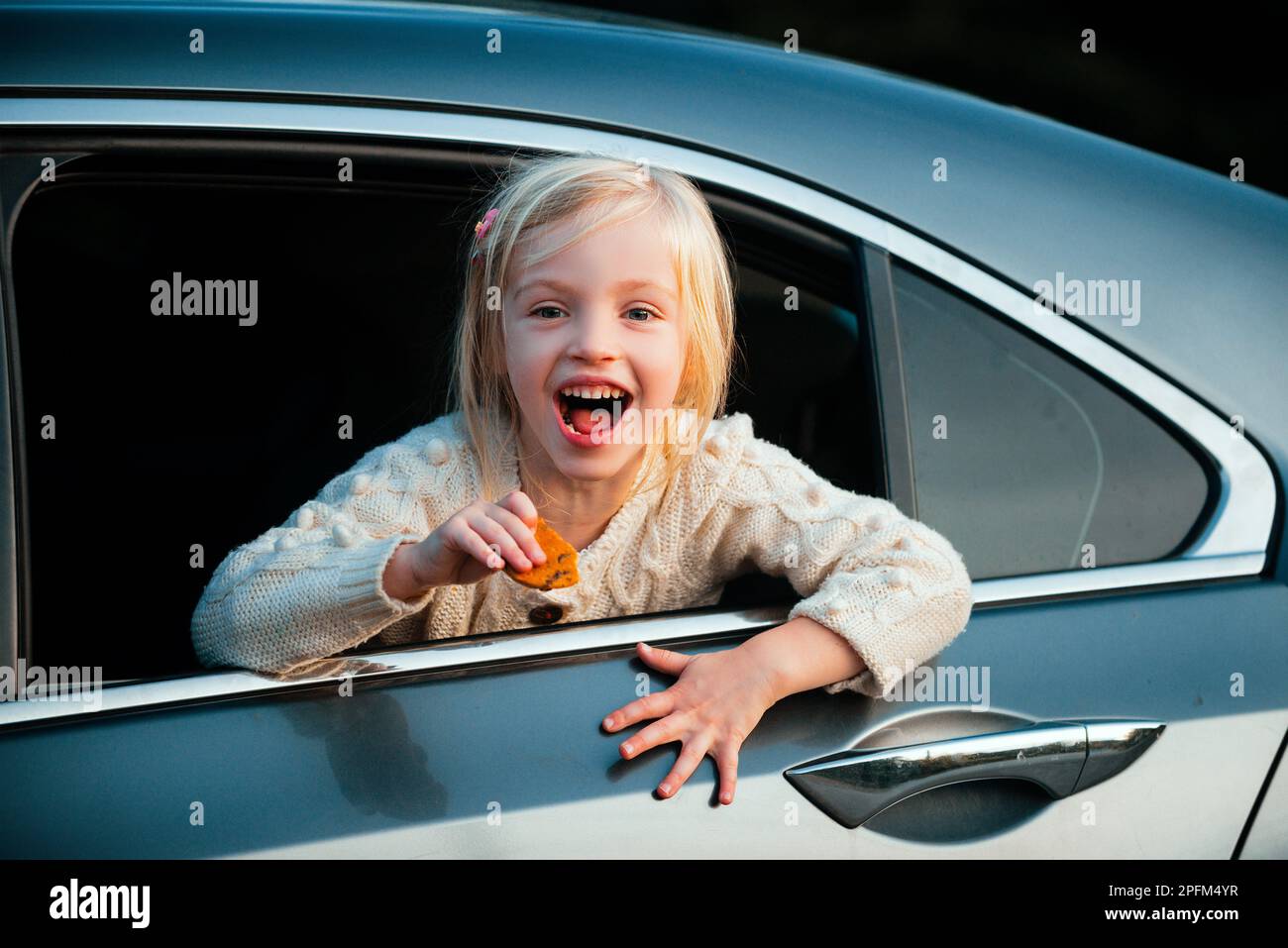 Excited little girl admiring looks of the car on the street. Cute ...