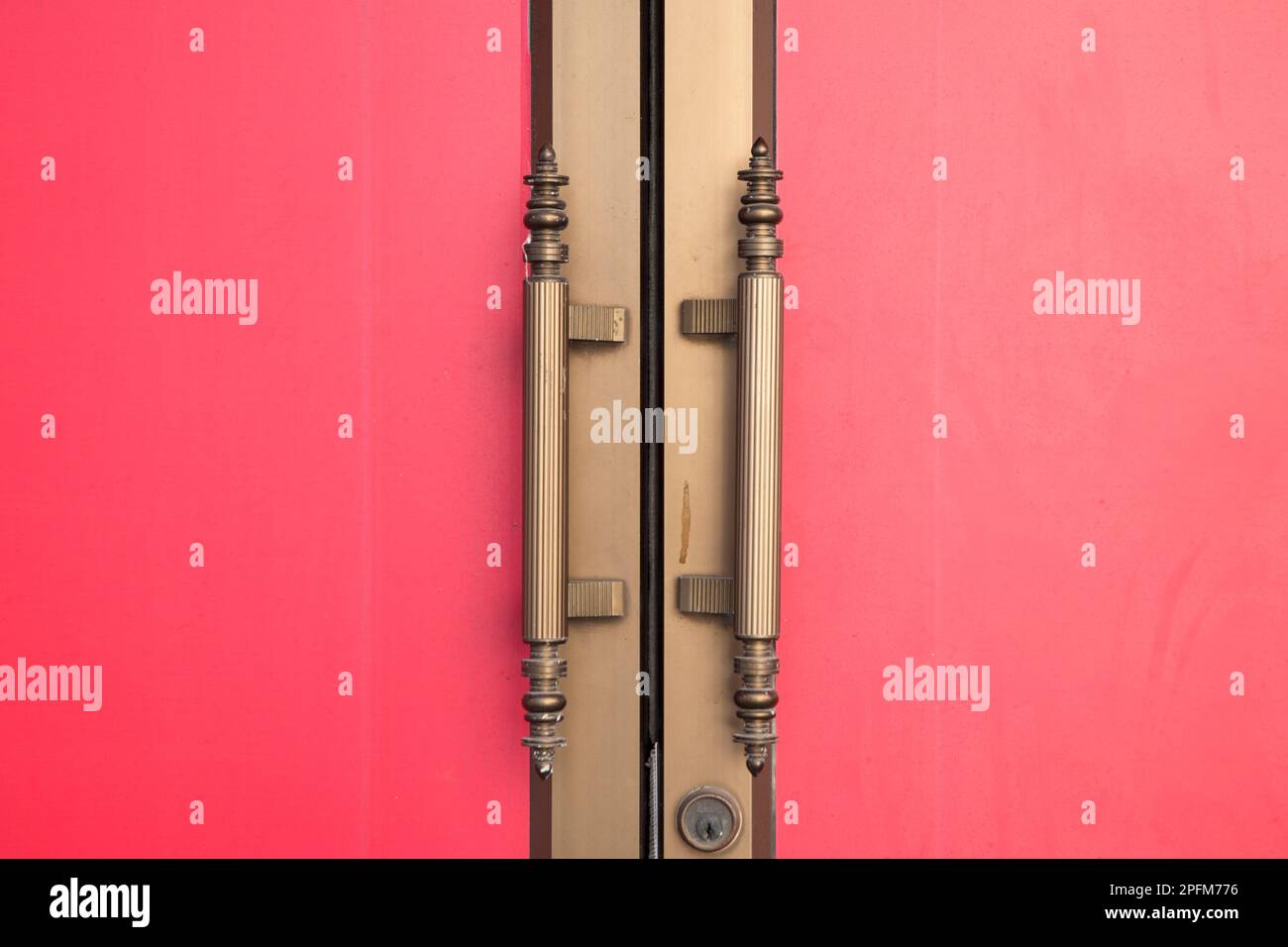 Metal door handle on red door. Close condition Stock Photo - Alamy