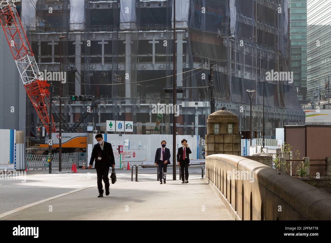 Japanese salarymen in front of the skyscrapers and the construction ...