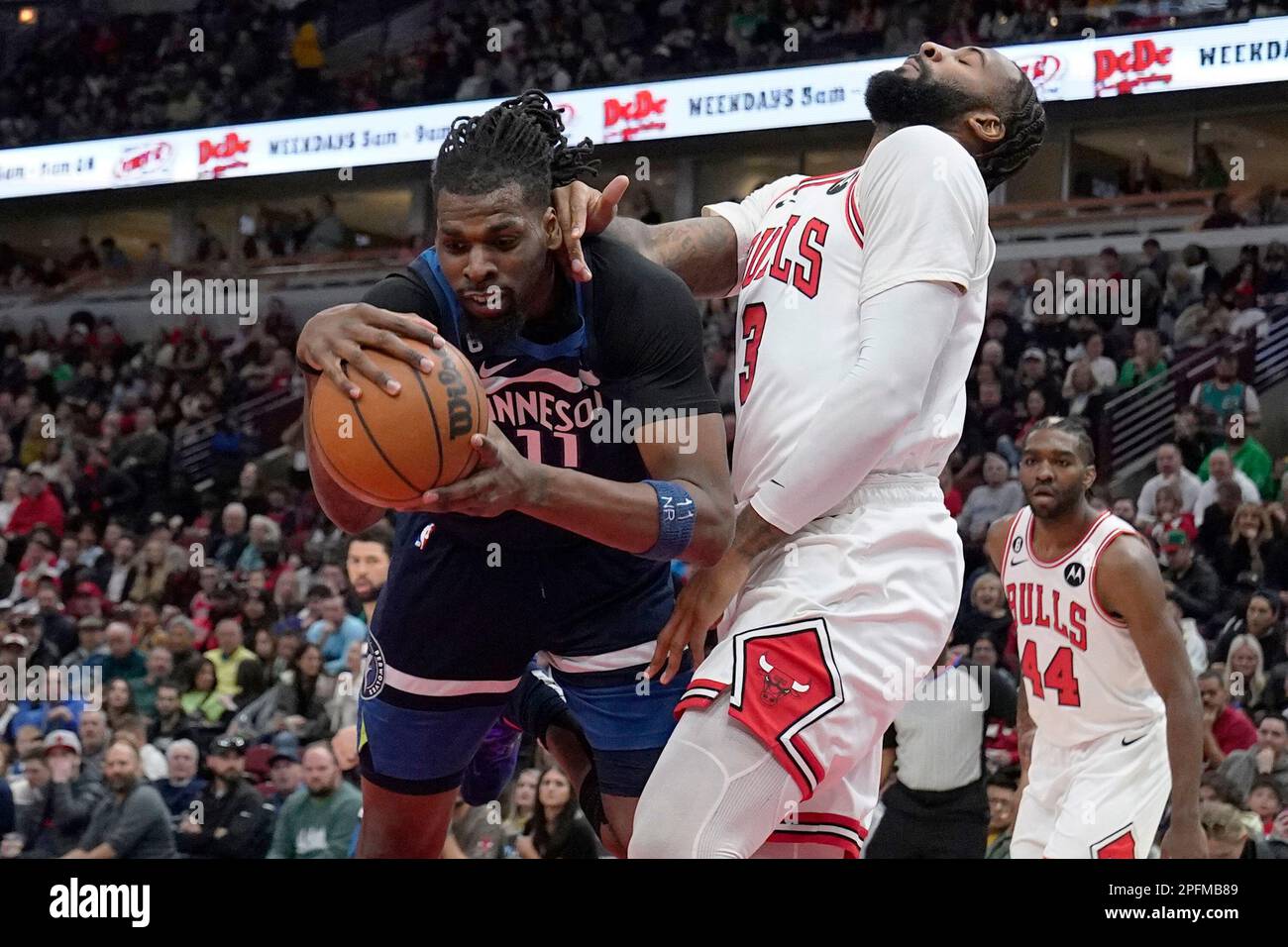 Minnesota Timberwolves center Naz Reid, left, pulls in a rebound next ...