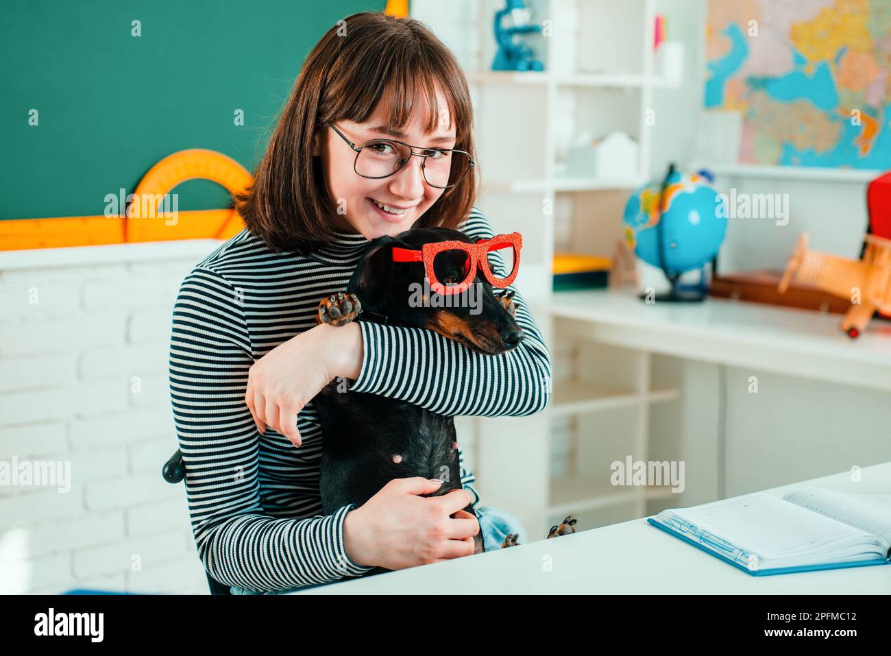 Puppy in glasses with funni student girl in glasses. Funny pupil ...