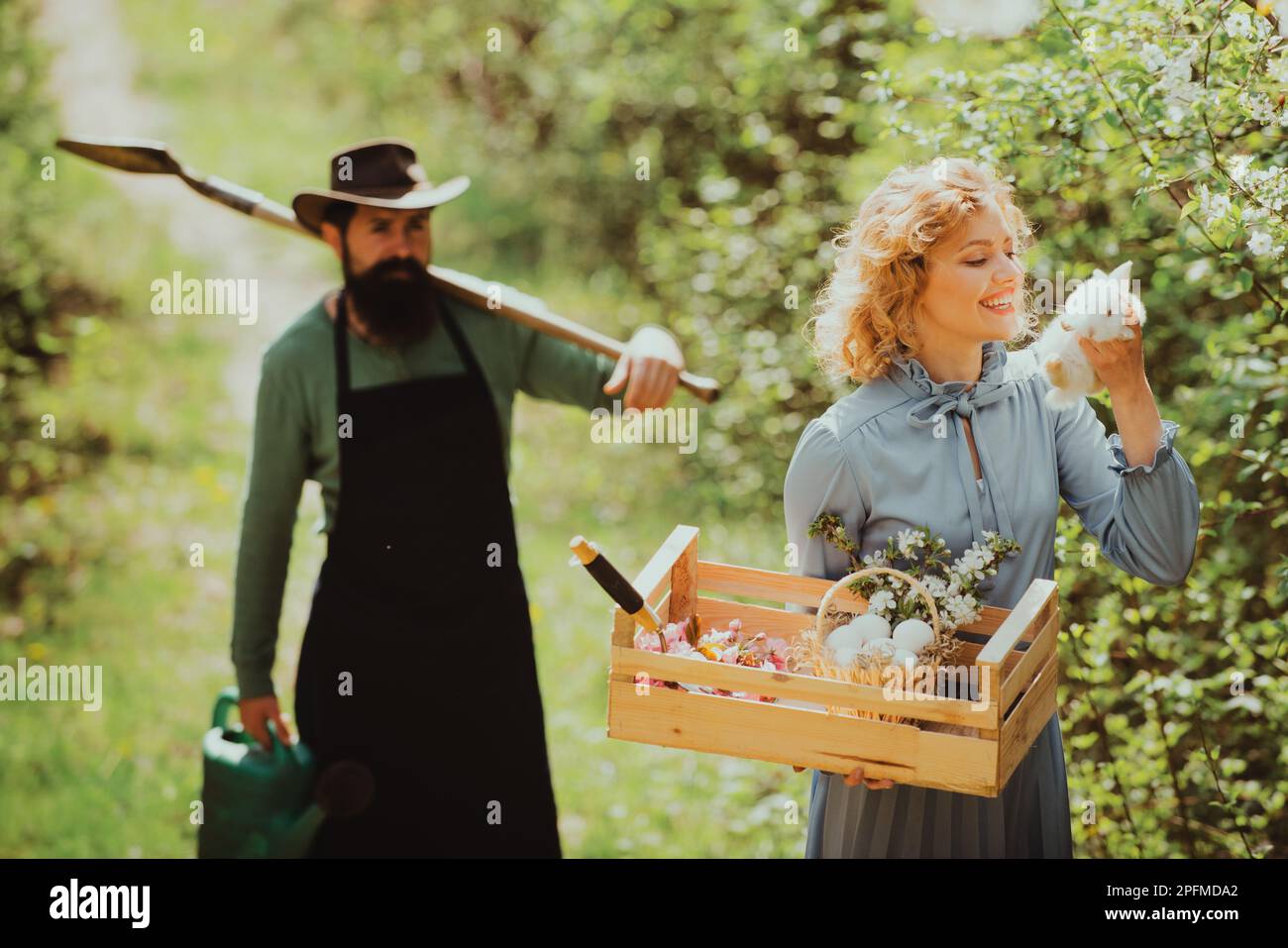 Happy Couple Farmers working with spud on spring field. Earth concept ...