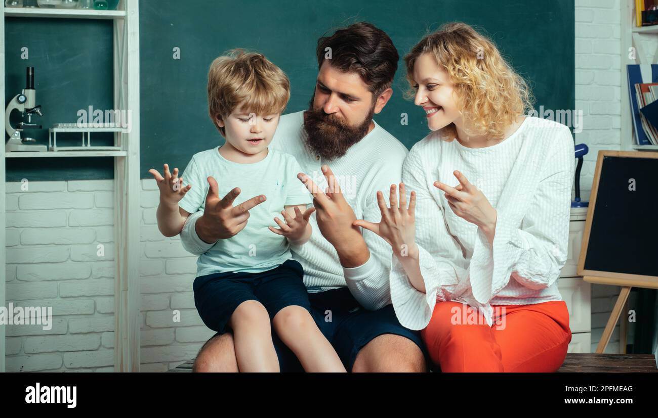 Family school. Funny little child with family having fun on blackboard ...
