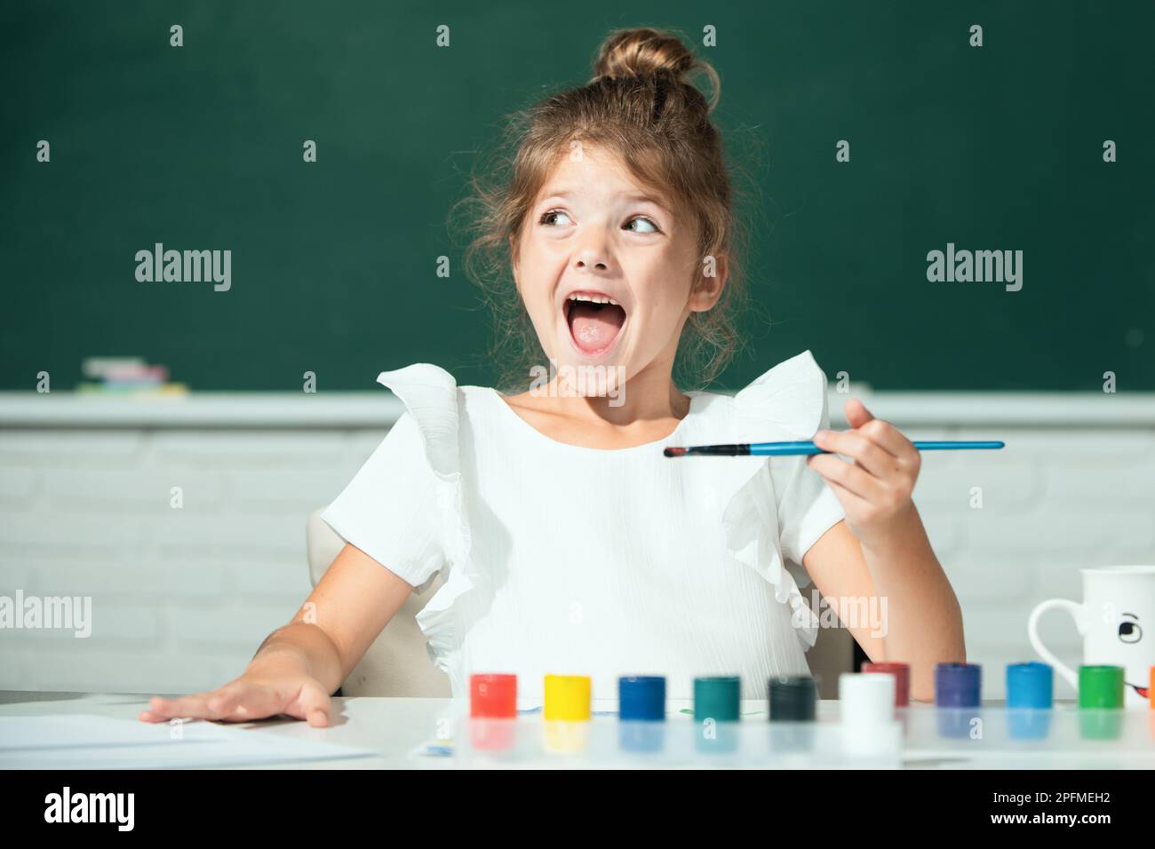 Child girl drawing with coloring pens paintind. Portrait of adorable ...