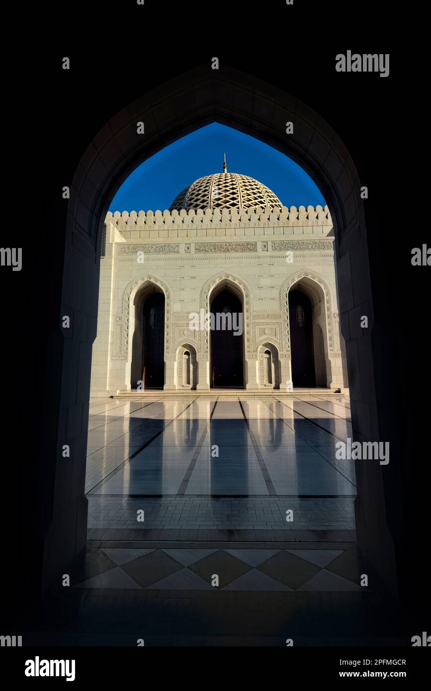 Looking through an arch at the Sultan Qaboos Grand Mosque, Muscat, Oman ...