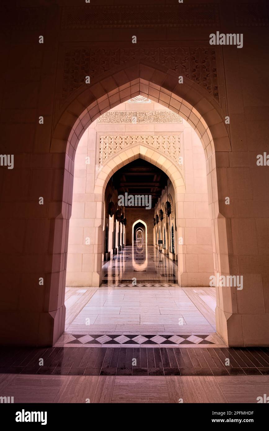Looking through an arch at the Sultan Qaboos Grand Mosque, Muscat, Oman ...