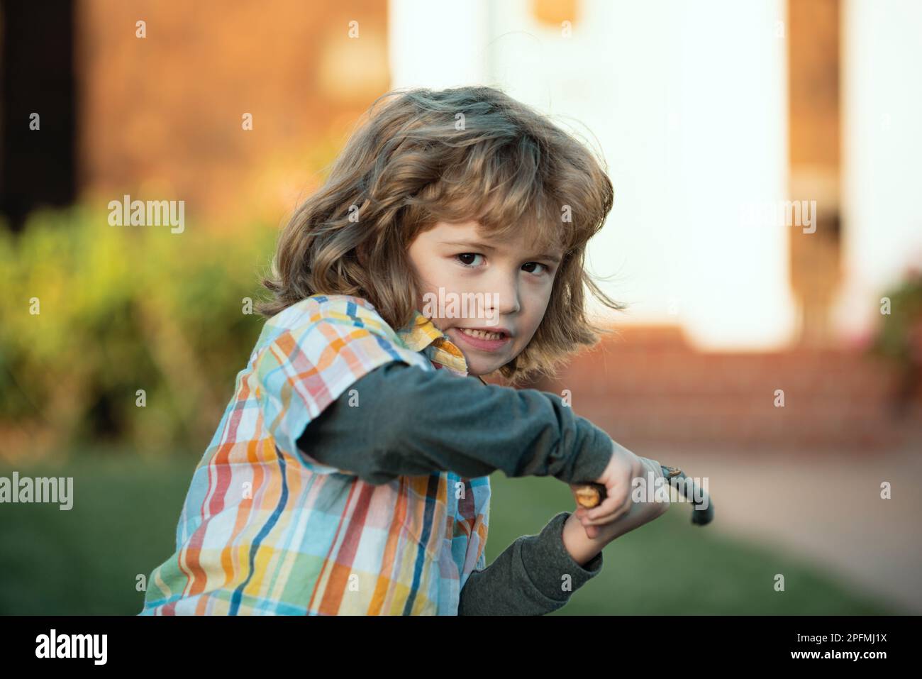 Negative child emotion. Kids aggression. Angry boy with stick. Kid ...