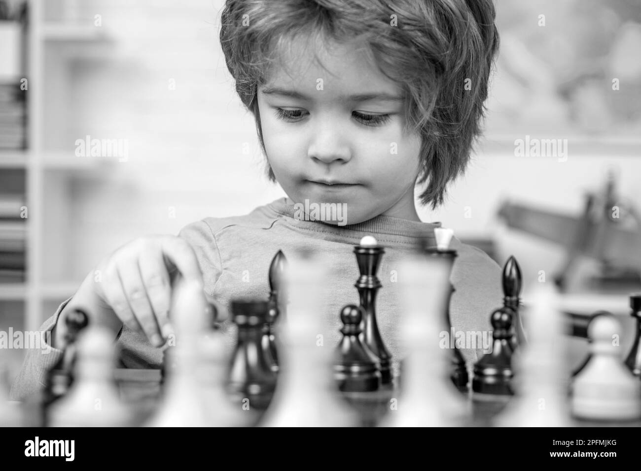 Chess strategy. Kid playing chess. Thinking kid Stock Photo - Alamy