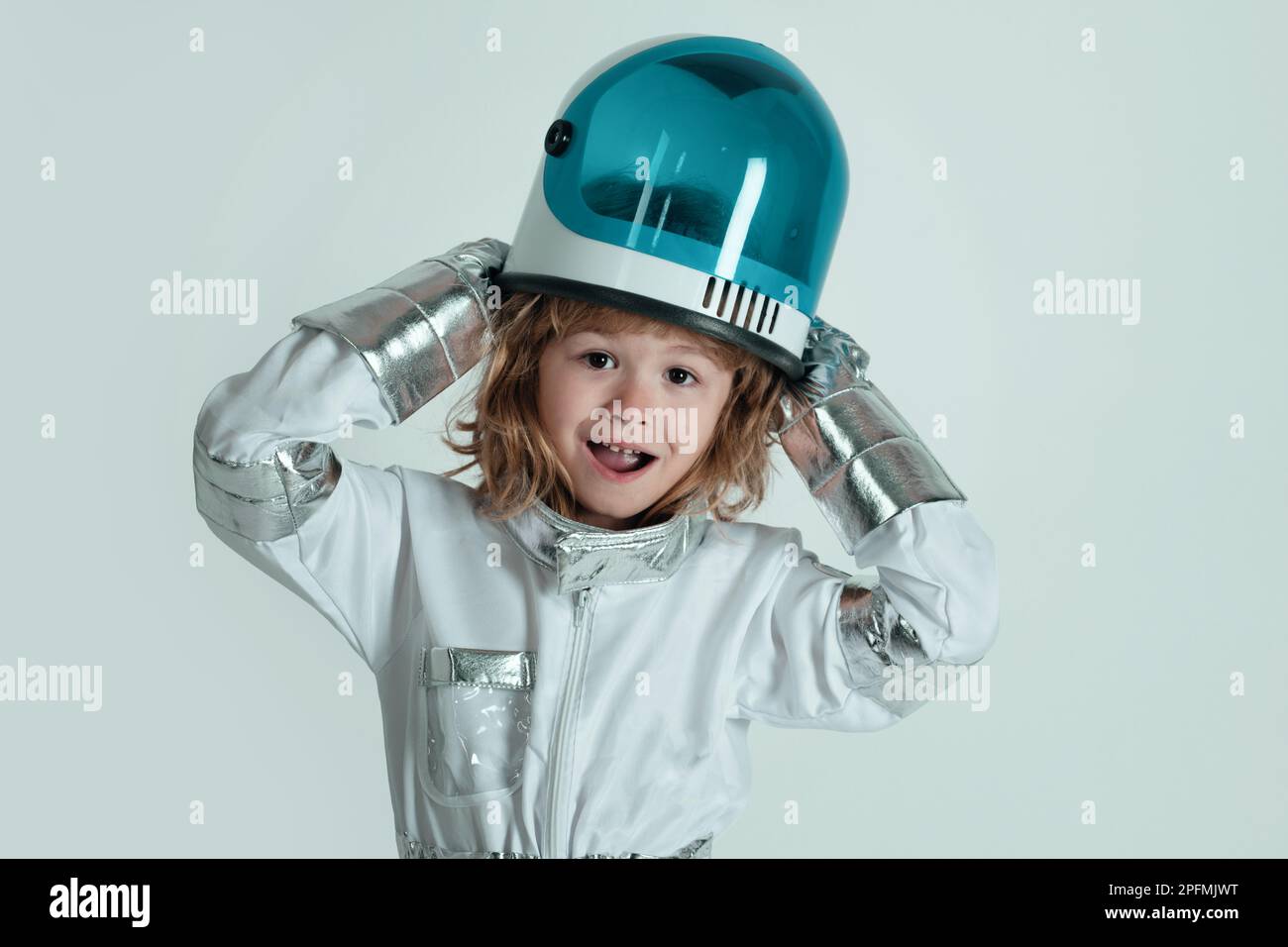 Close-up face of little astronaut with helmet looking dreamily. Little ...