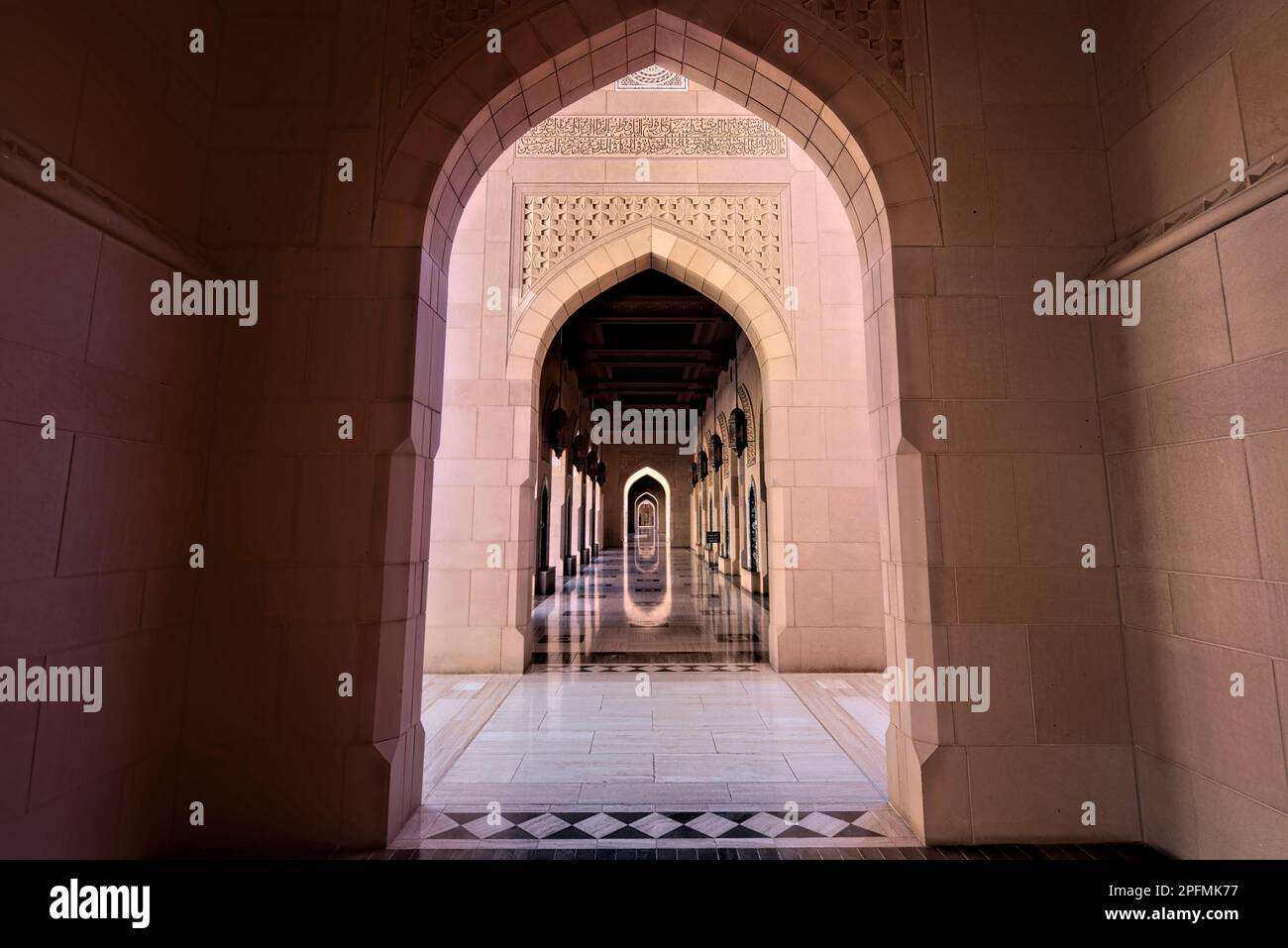 Looking through an arch at the Sultan Qaboos Grand Mosque, Muscat, Oman ...