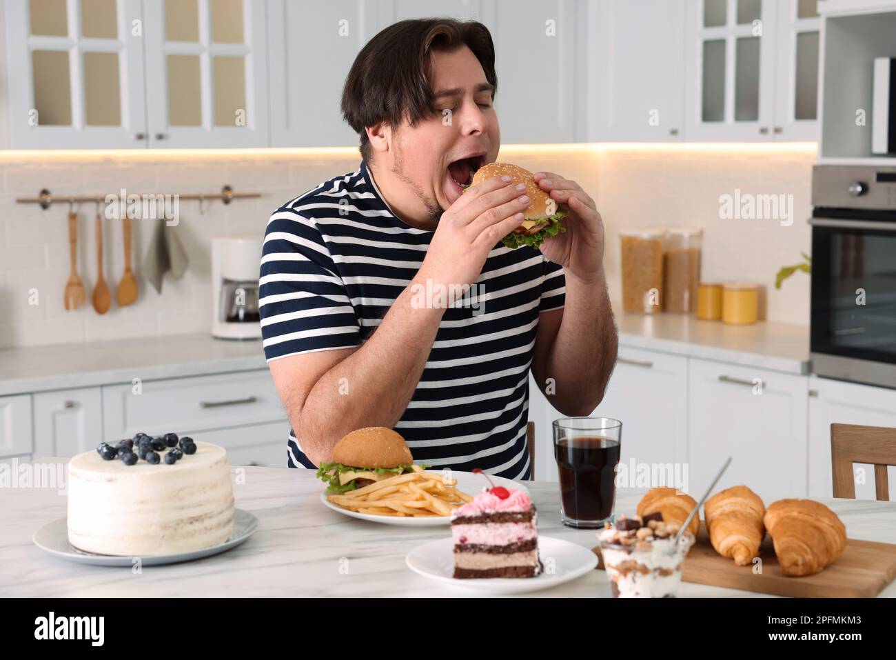 Glutton eating hi-res stock photography and images - Alamy
