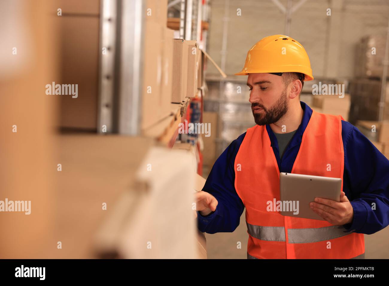 Man with tablet working at warehouse. Logistics center Stock Photo - Alamy