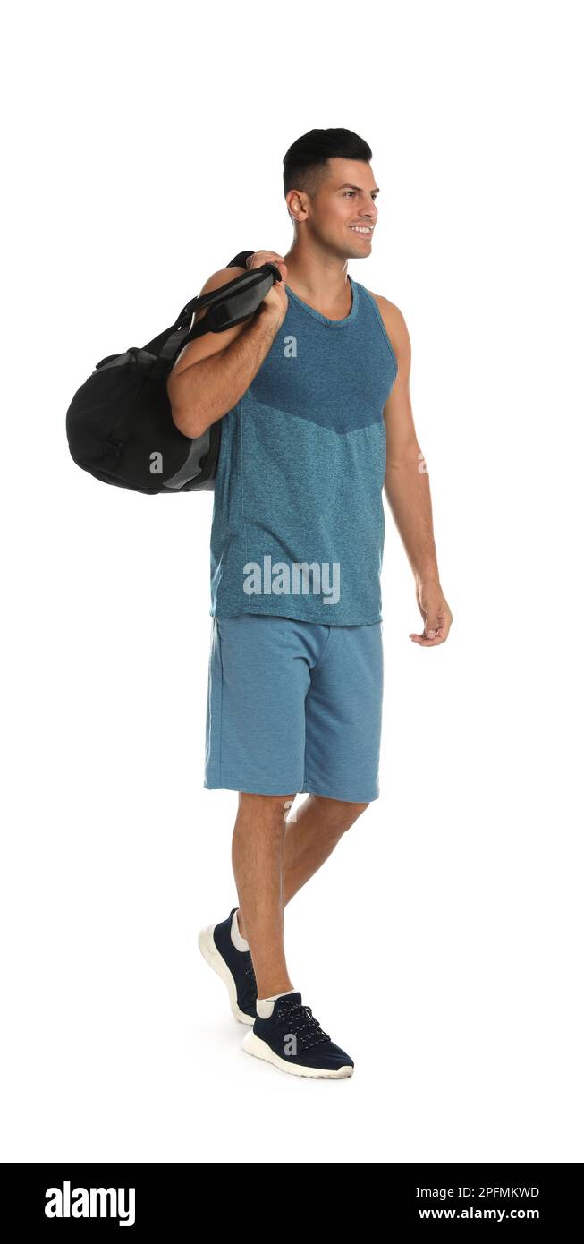 Handsome man with sports bag on white background Stock Photo - Alamy