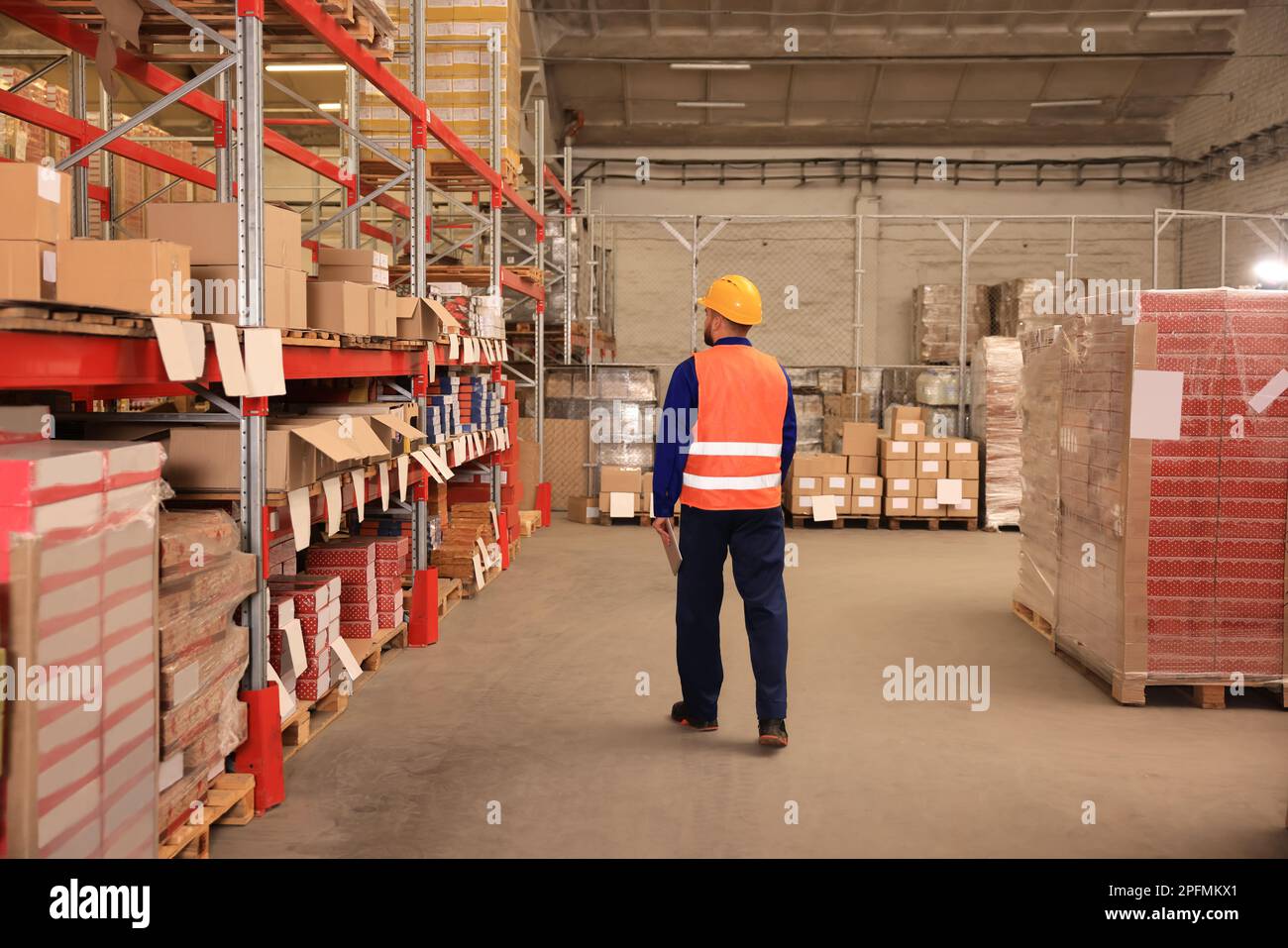 Man with tablet working at warehouse, back view. Logistics center Stock ...