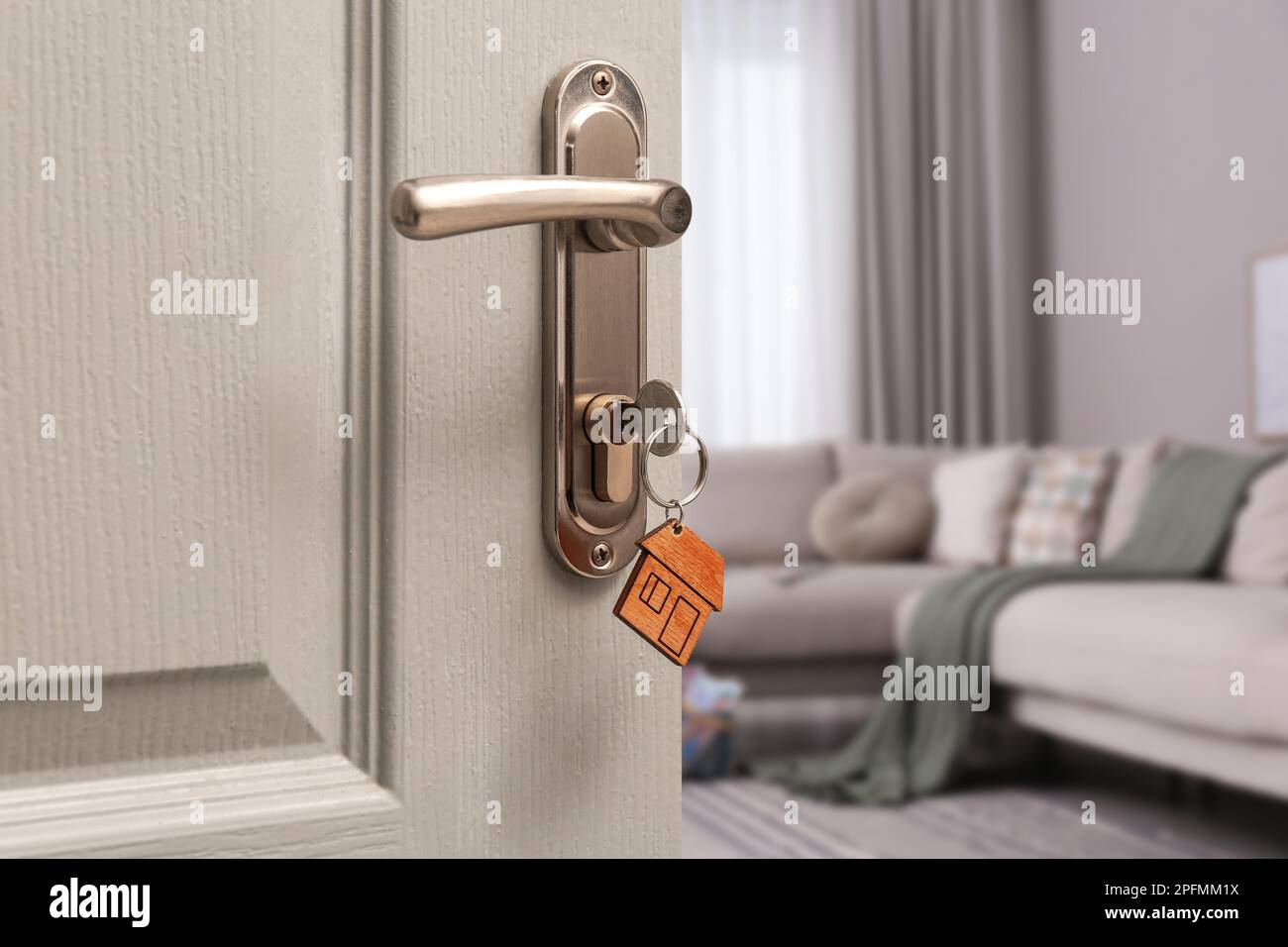 Closeup view of door with key open in living room Stock Photo - Alamy
