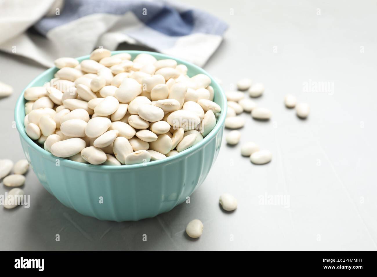 Raw white beans on light grey table, closeup. Space for text Stock ...