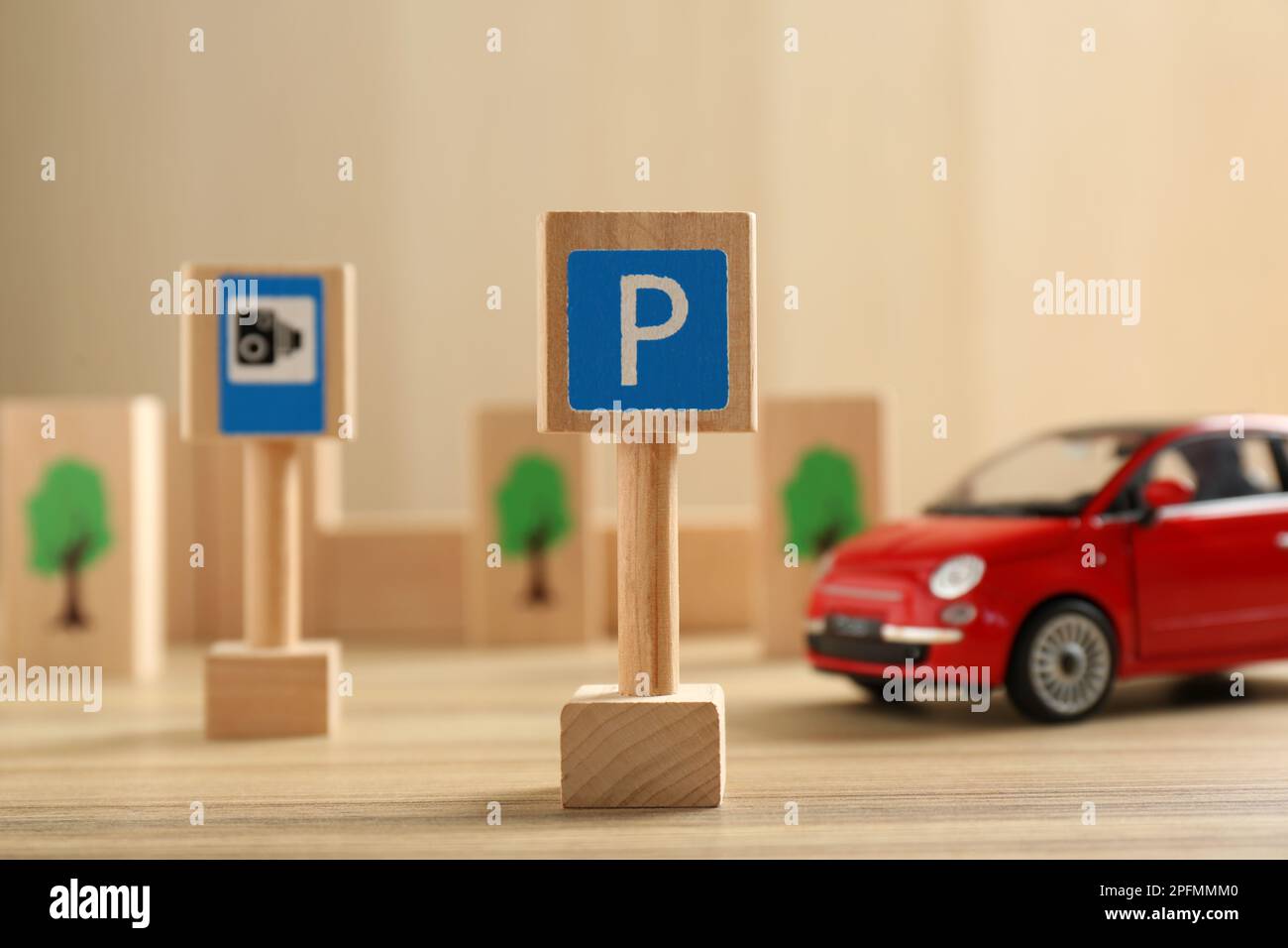 Traffic sign Parking lot and toy car on wooden table. Passing driving ...