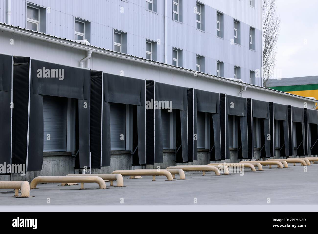 Warehouse with loading docks outdoors. Logistics center Stock Photo - Alamy