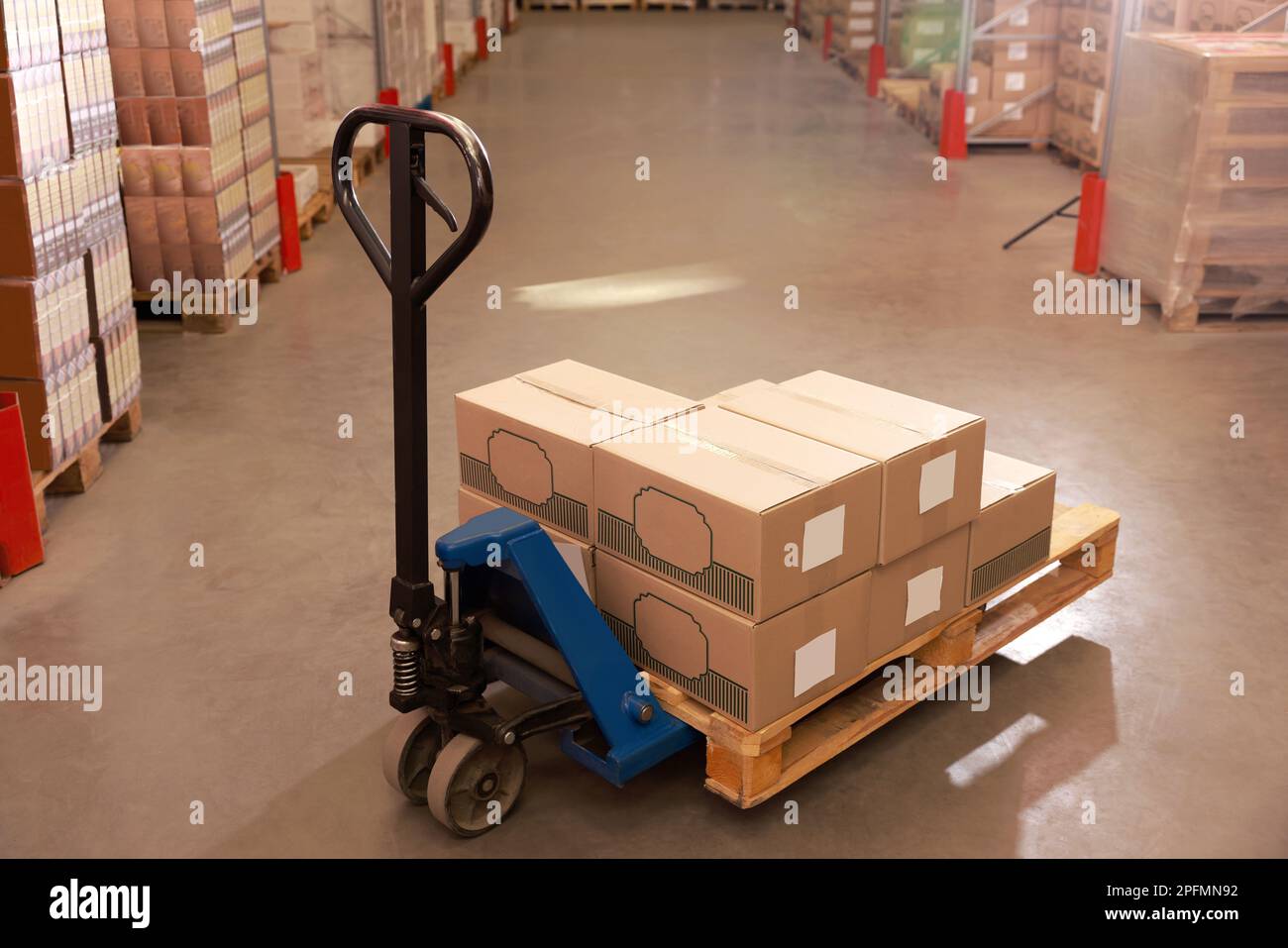 Manual forklift with cardboard boxes in warehouse. Logistics concept ...