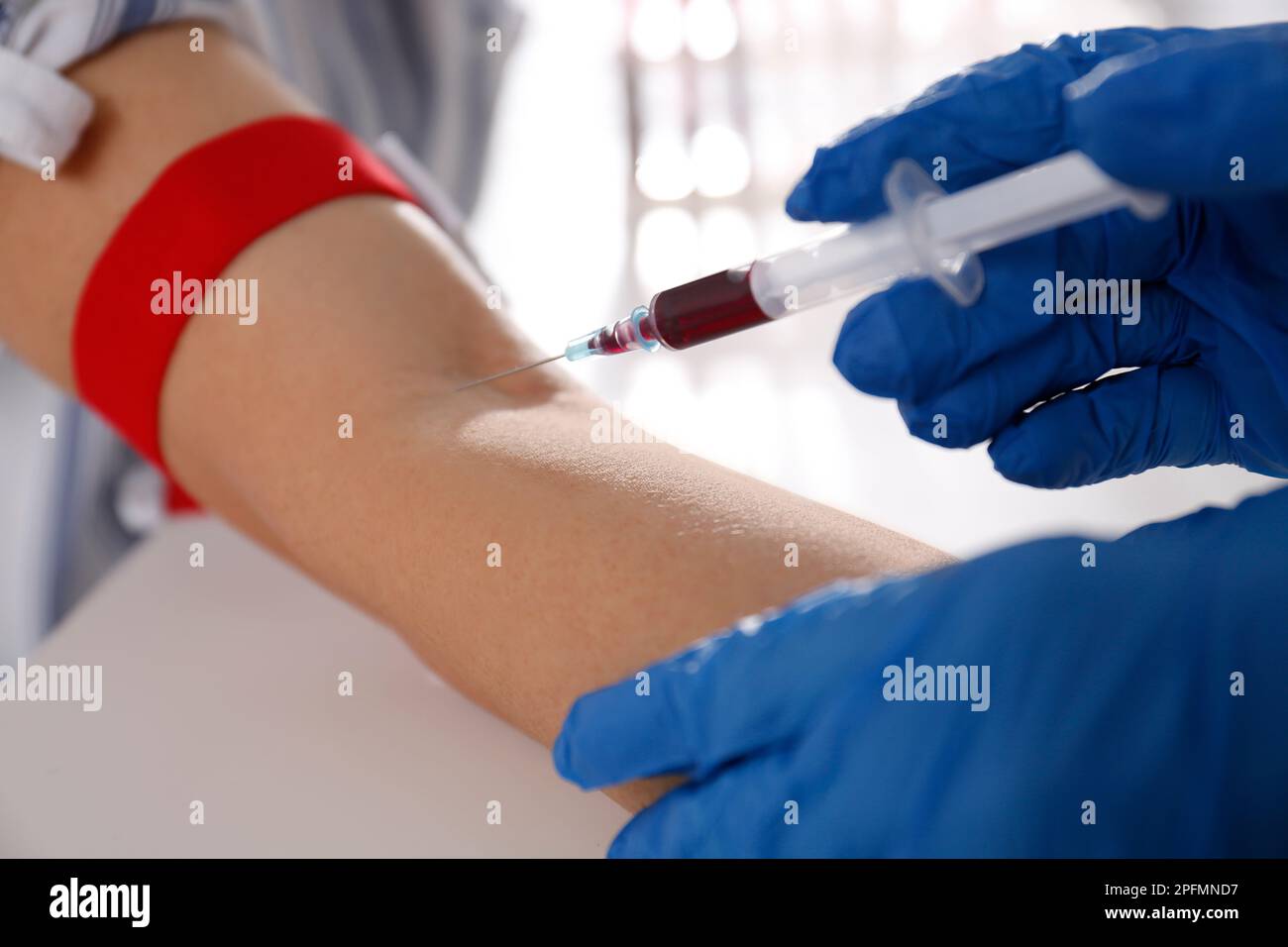 Nurse drawing blood sample from patient in clinic, closeup Stock Photo ...