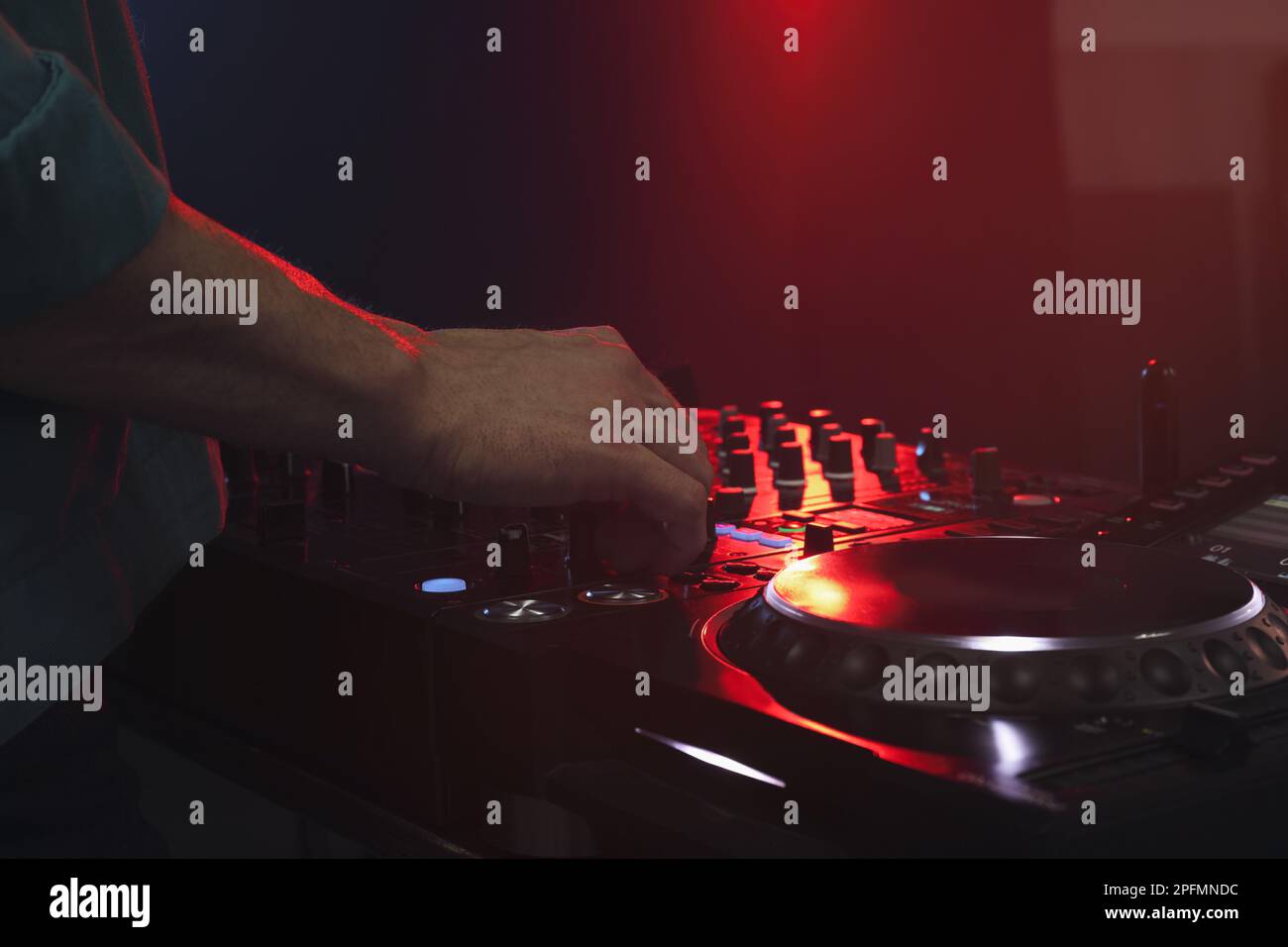 DJ creating music on modern console mixer in night club, closeup Stock ...