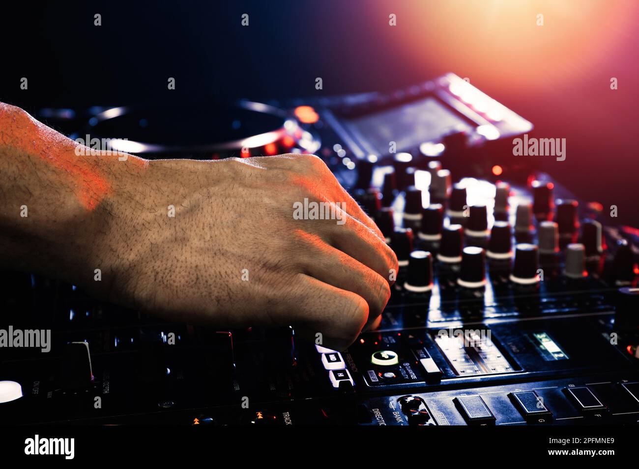 DJ creating music on modern console mixer in night club, closeup Stock ...
