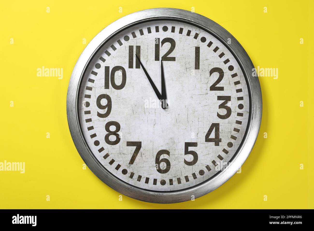 Clock showing five minutes until midnight on yellow background. New ...