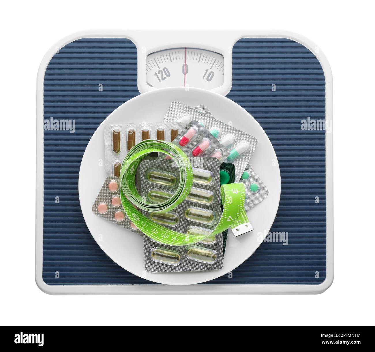 Scales with plate of pills and measuring tape on white background, top ...
