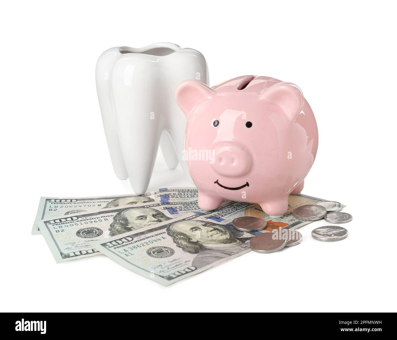Ceramic model of tooth, piggy bank and money on white background ...