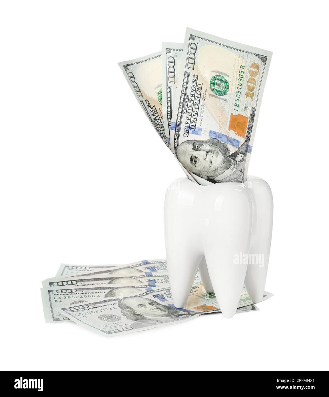 Ceramic model of tooth and dollar banknotes on white background ...