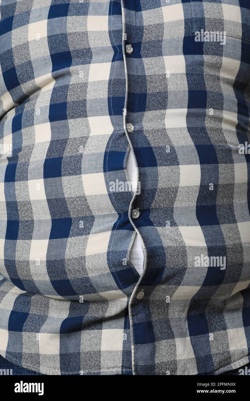 Closeup view of overweight man in tight shirt as background Stock Photo ...
