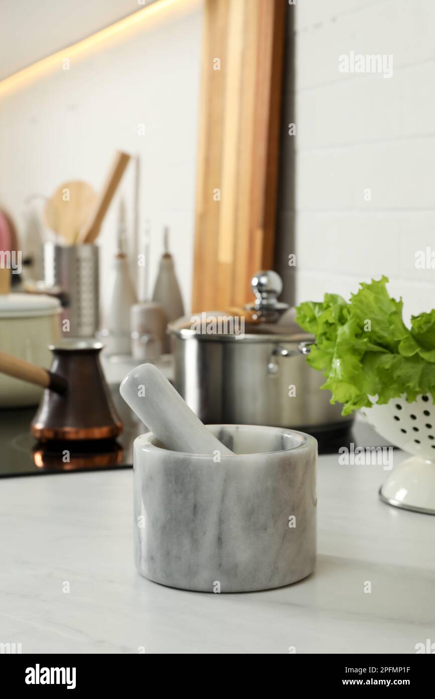 Marble mortar with pestle on kitchen counter. Cooking utensils Stock ...