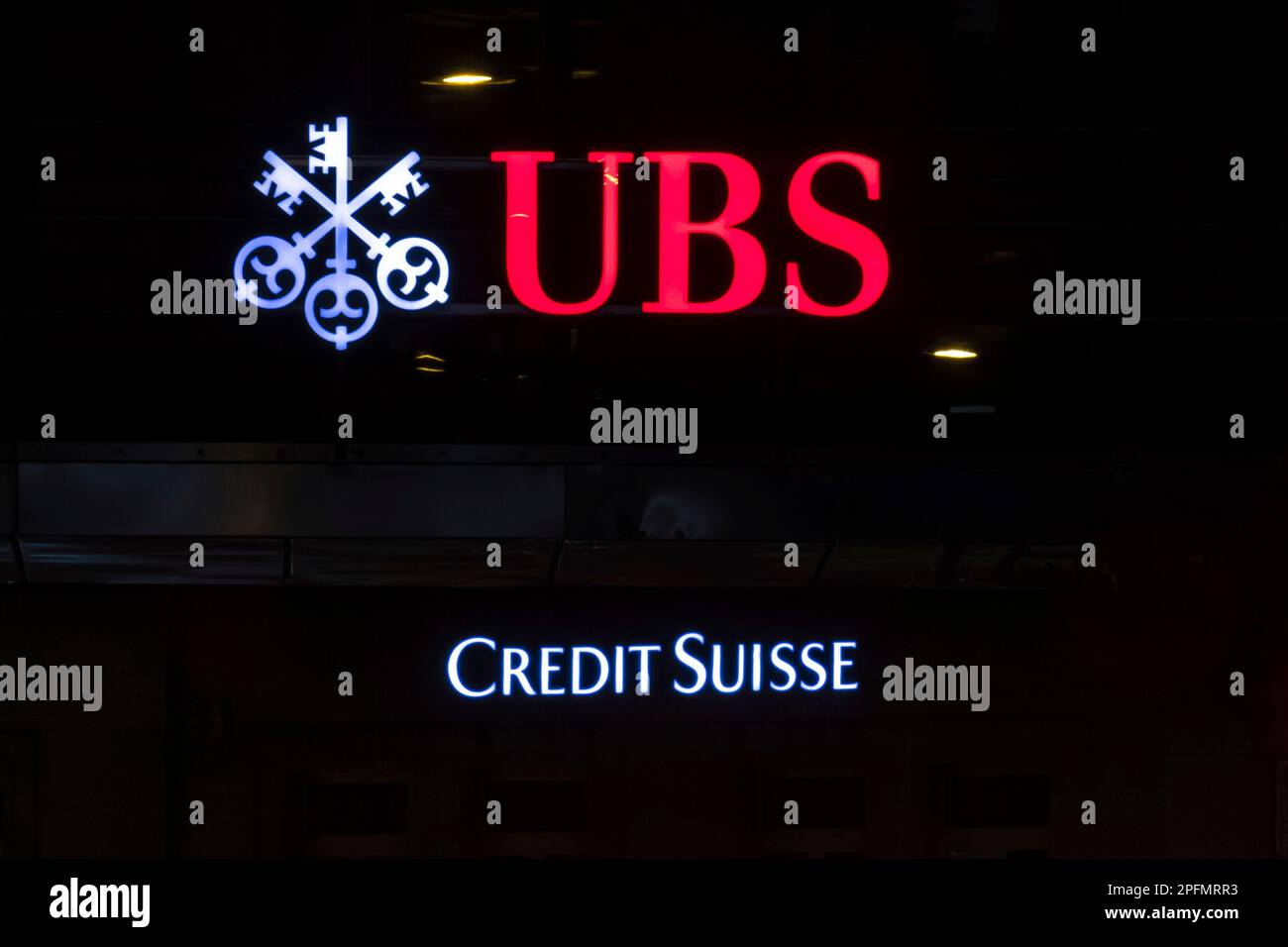 The illuminated logos of the Swiss banks Credit Suisse and UBS are seen ...