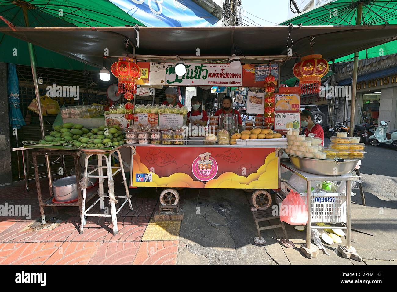 A push-cart stall selling mango glutinous 'sticky' rice, cut pomelo ...