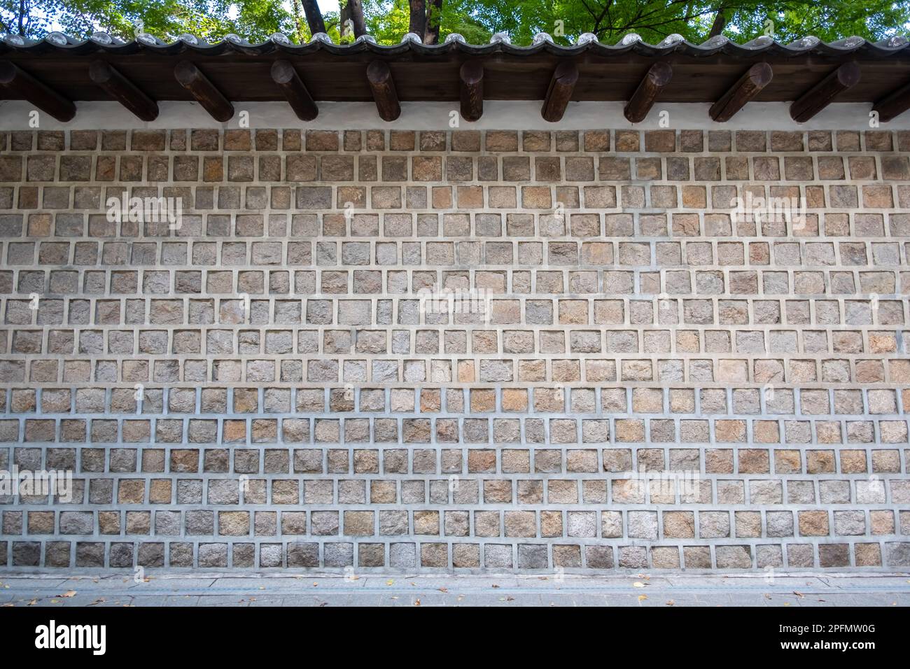 Traditional Korean stone wall boundary with roof Stock Photo - Alamy