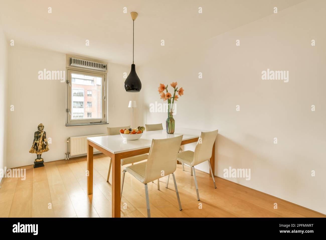 a dining table and chairs in a room with white walls, hardwood flooring ...