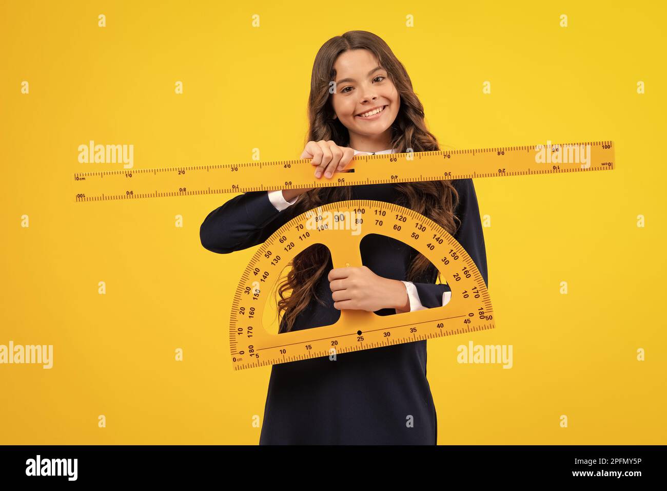 Measuring school equipment. Schoolgirl holding measure for geometry ...
